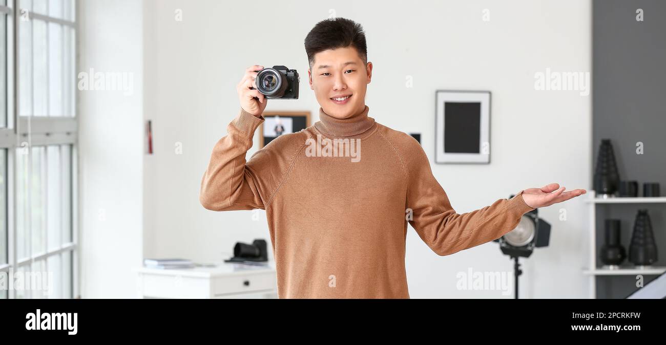 Happy young Asian photographer in modern studio Stock Photo - Alamy