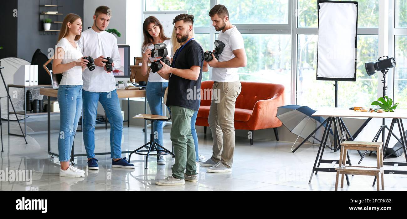 Group of young photographers in studio Stock Photo - Alamy