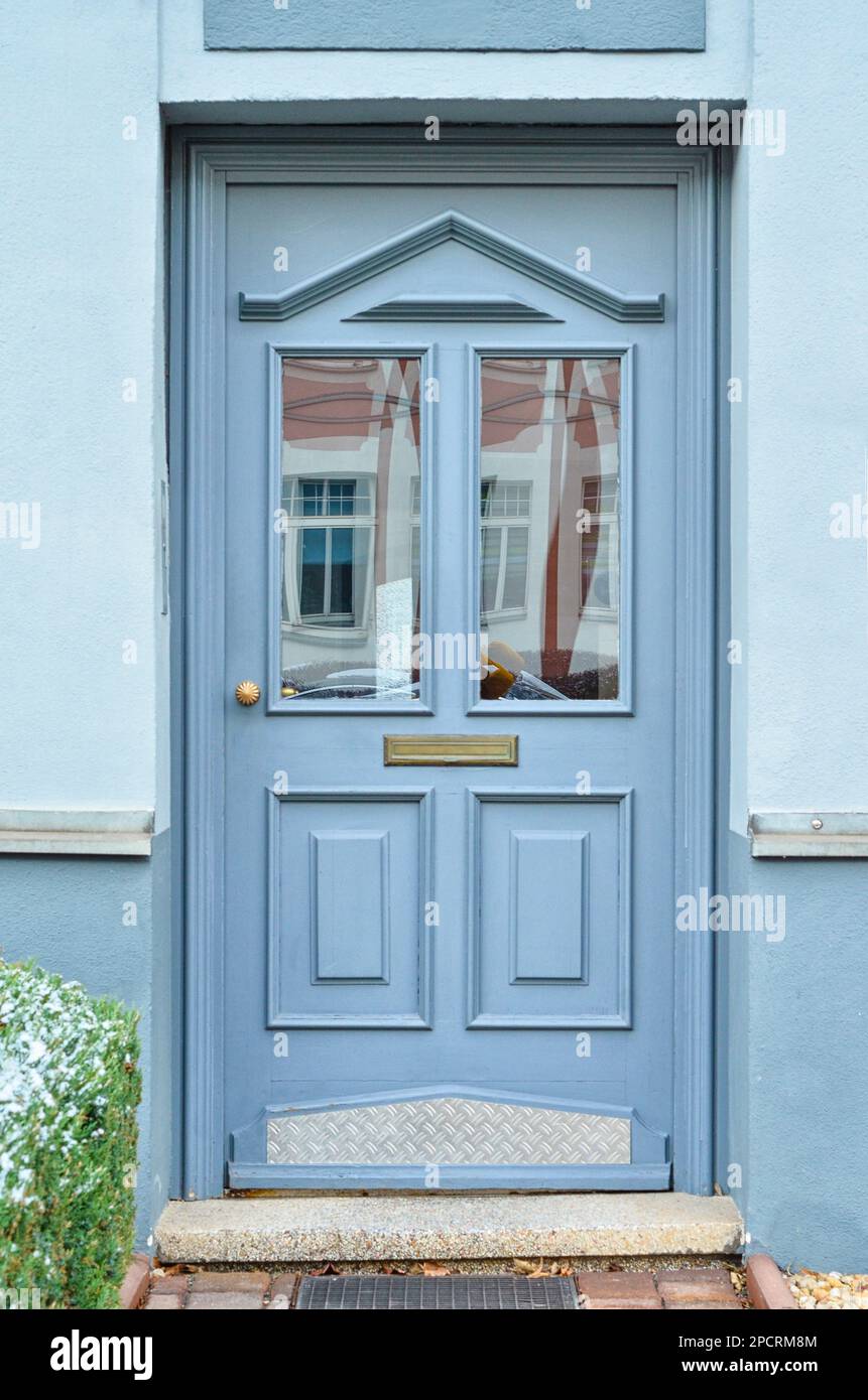 View of city building with grey wooden door Stock Photo - Alamy