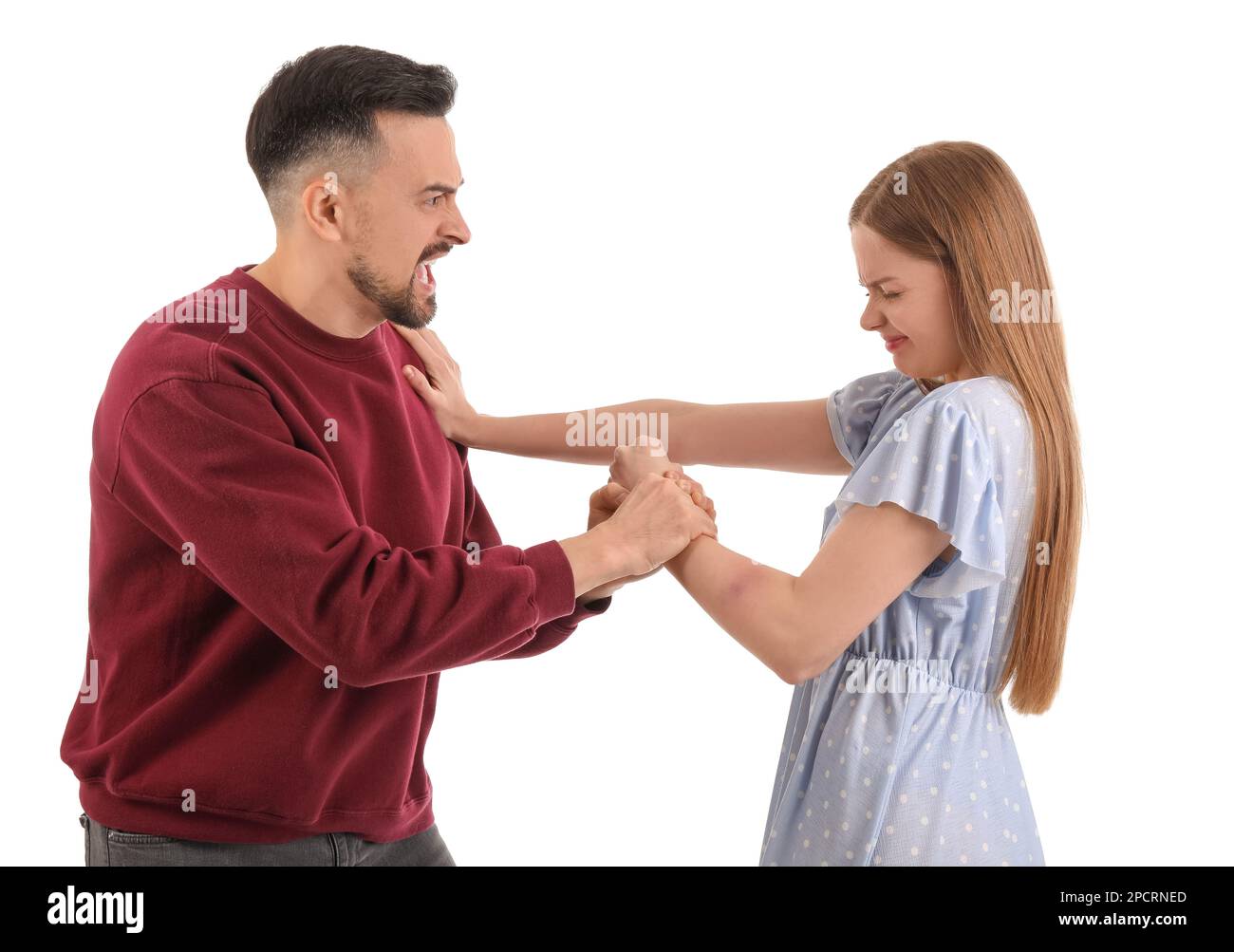 Angry young man hurting his wife on white background. Domestic violence ...