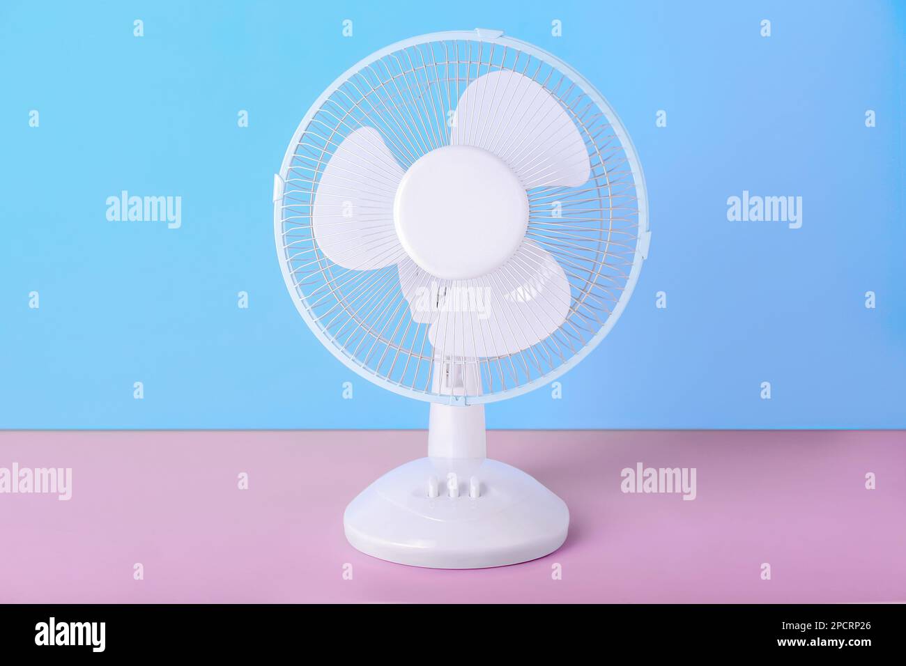 Electric fan on blue background Stock Photo - Alamy