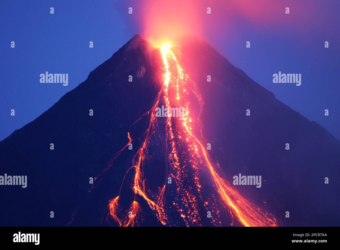 Red-hot lava pours down the slopes of Mayon volcano as seen from ...