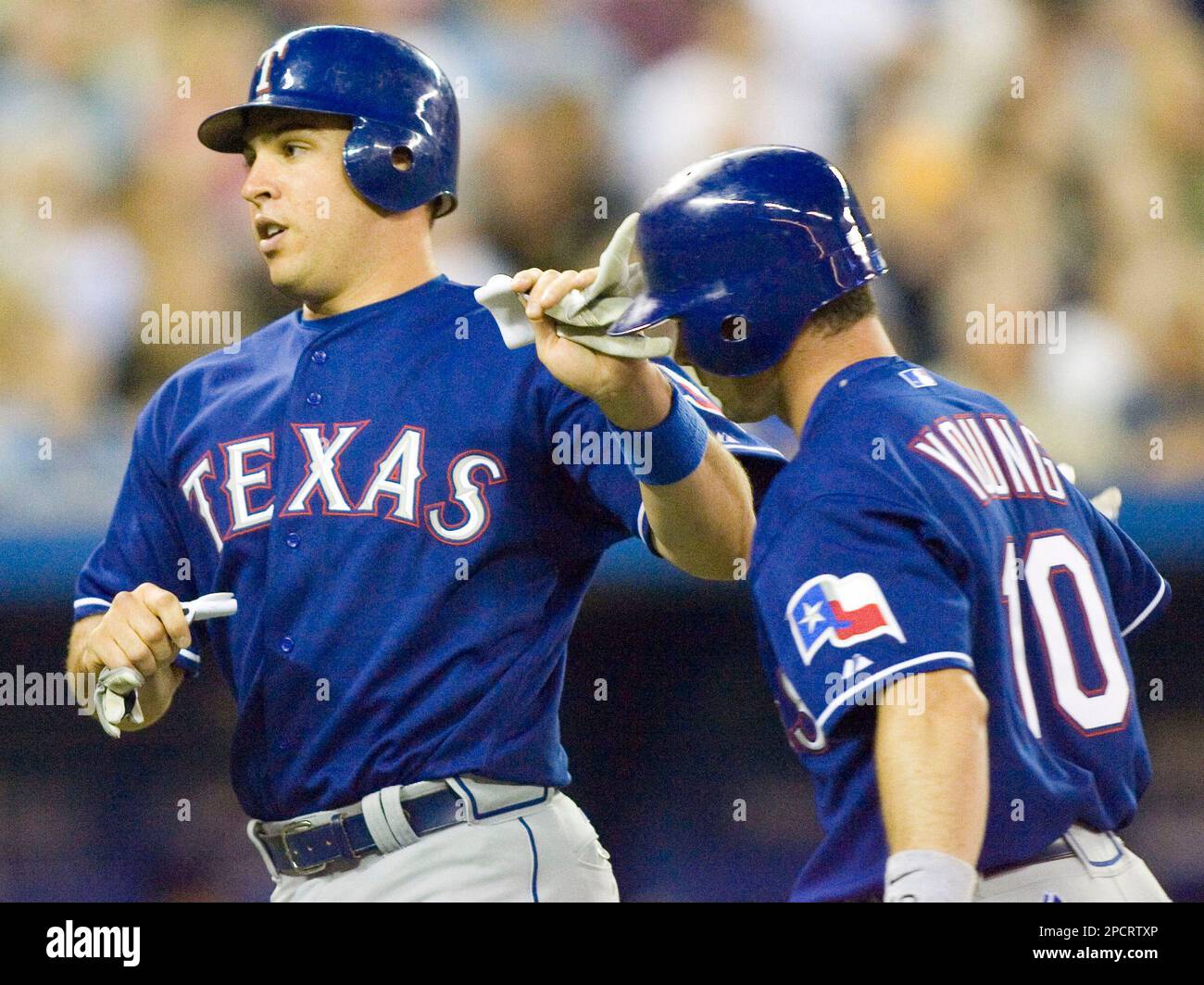 Texas Rangers' Michael Young and Mark Teixeira celebrate after crossing ...