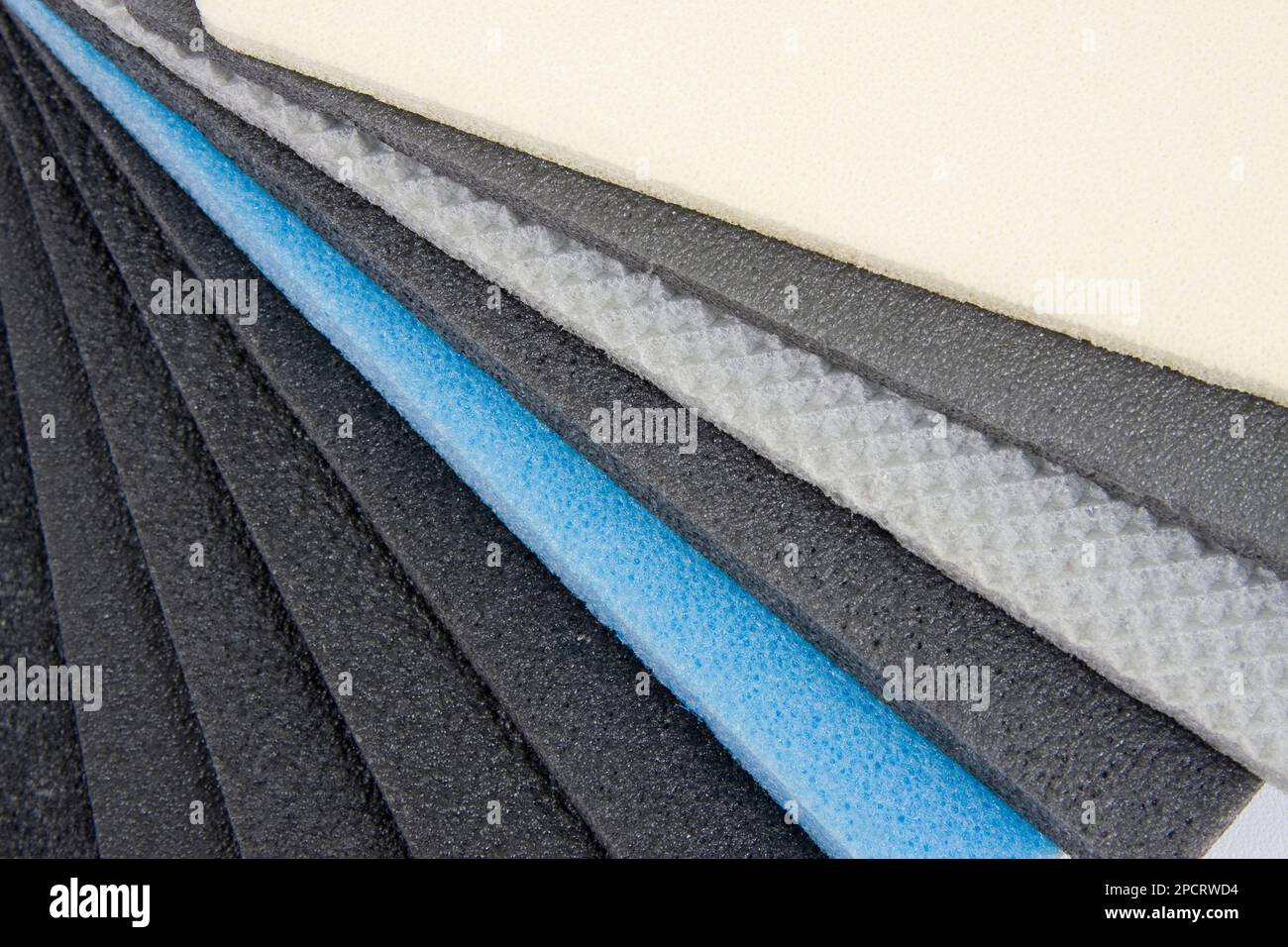 Roll of gray foam rubber sheet isolated in white. High quality photo ...