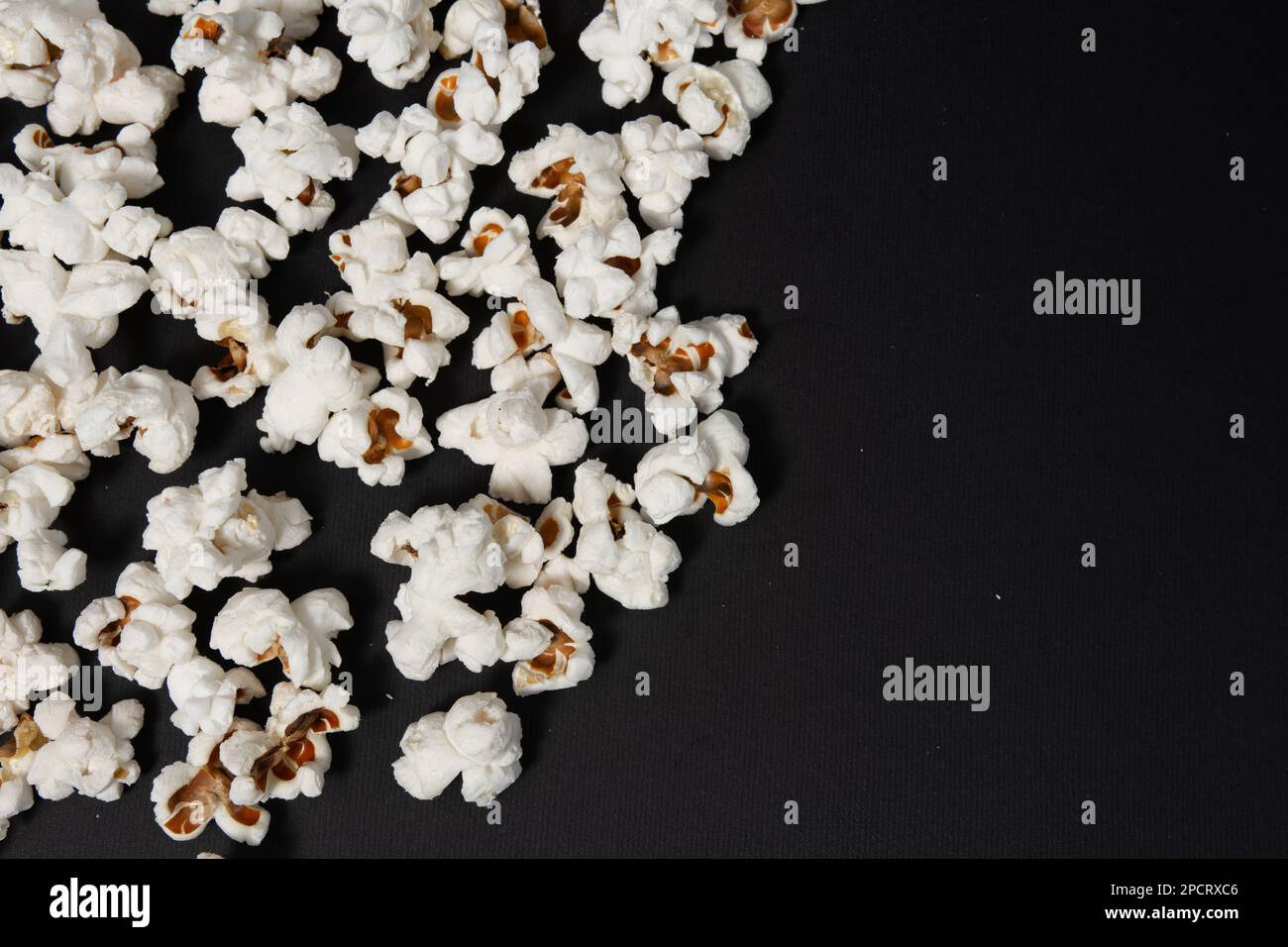 fried popcorn on black background close-up, ready-to-eat food, corn ...