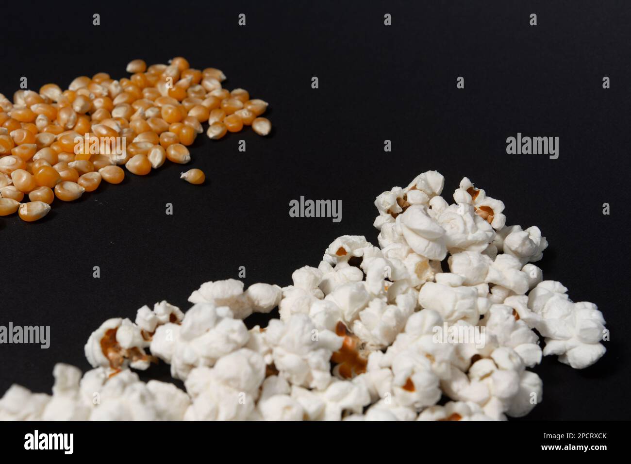 Corn and popcorn grains in two rows on a black background Stock Photo ...