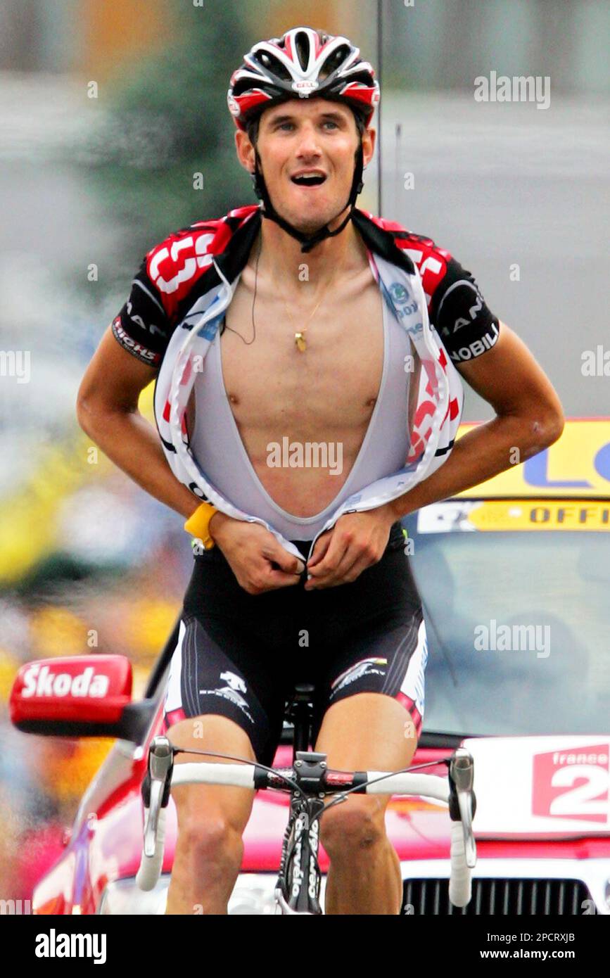 Frank Schleck of Luxembourg zips up his jersey shortly before crossing ...