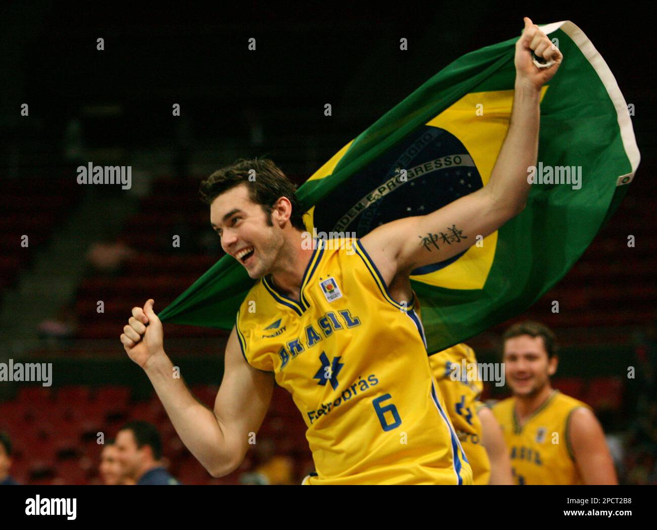 Brazil's Murilo Becker carries his nation's flag as he celebrates his ...