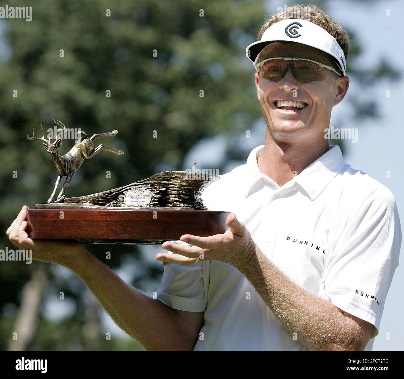 John Senden of Australia, smiles as he holds up the John Deere Classic ...