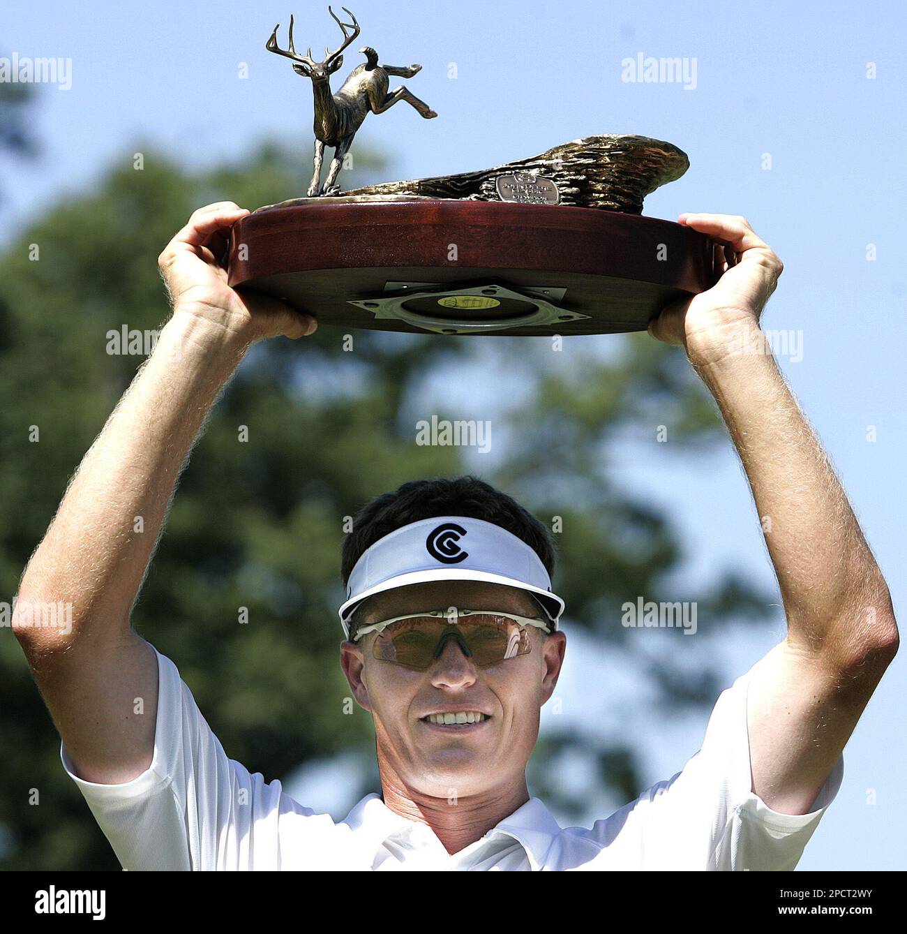 John Senden of Australia, holds up the John Deere Classic trophy after ...