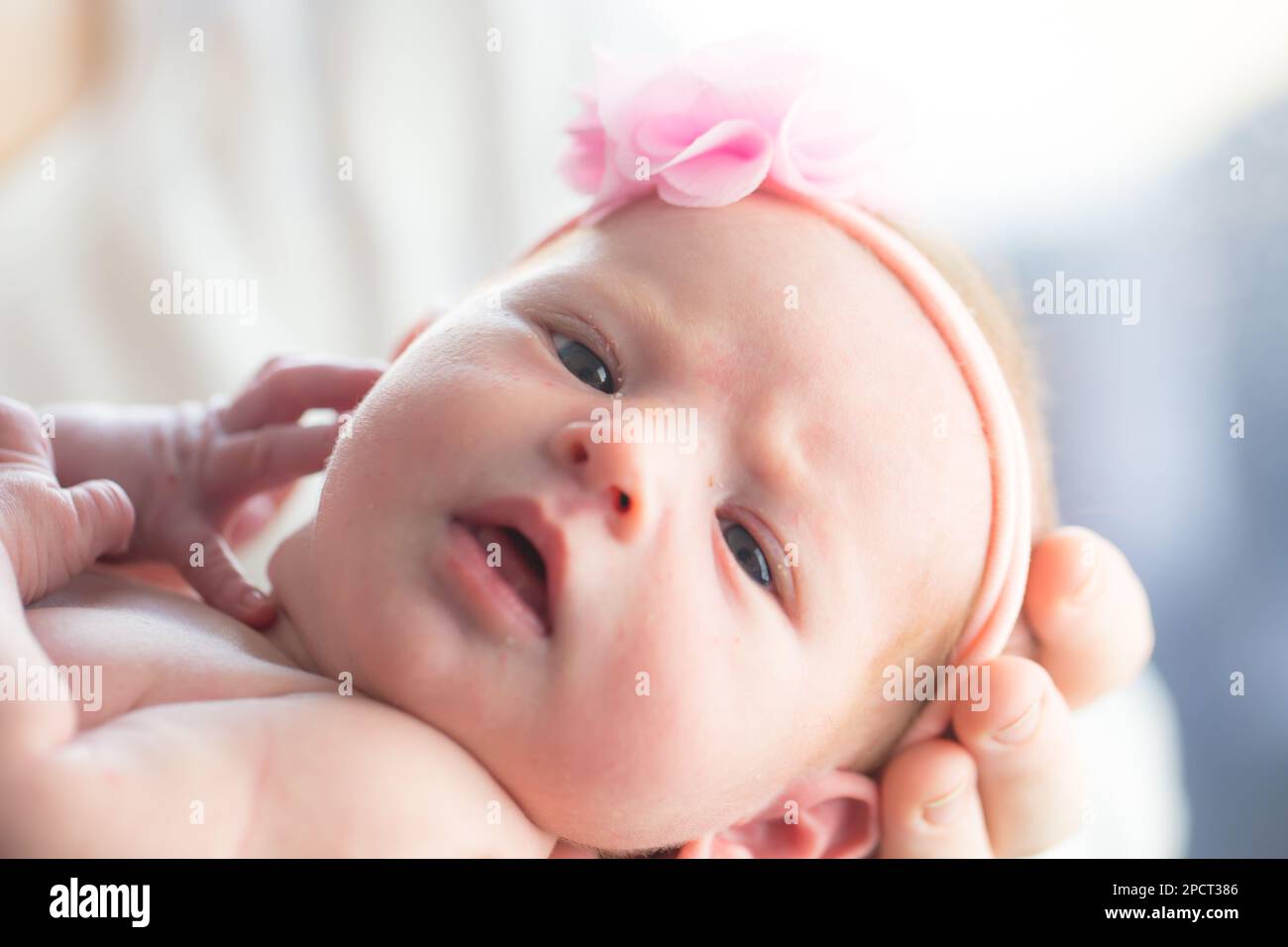 New born baby girl being held hi-res stock photography and images - Alamy