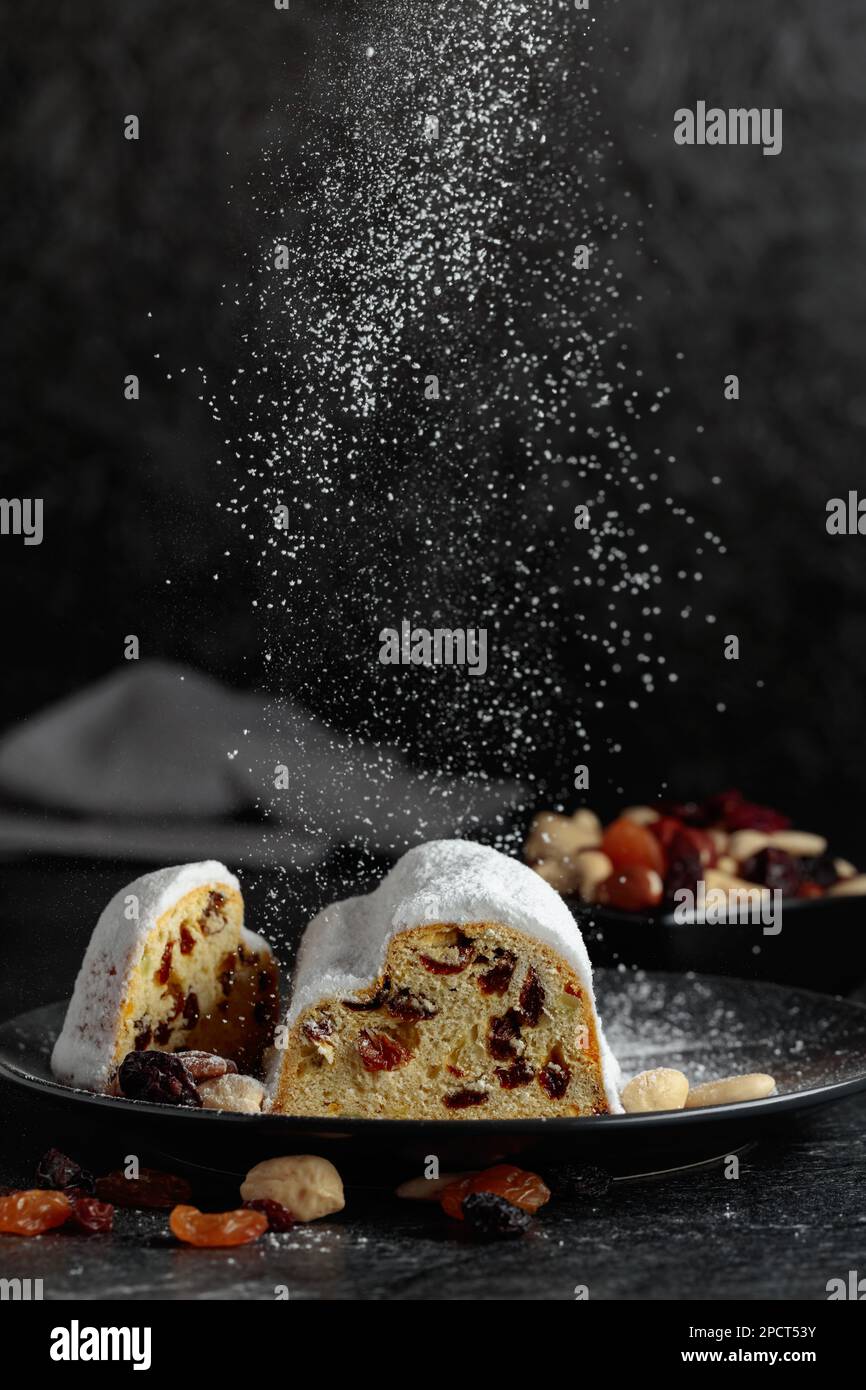 Traditional fruit cake with raisins and nuts sprinkled with sugar ...