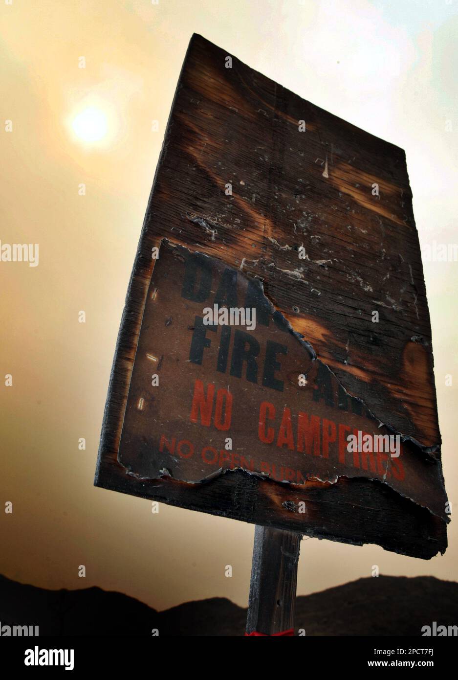 A burned sign warning of fire danger is seen in Burns Canyon Friday ...