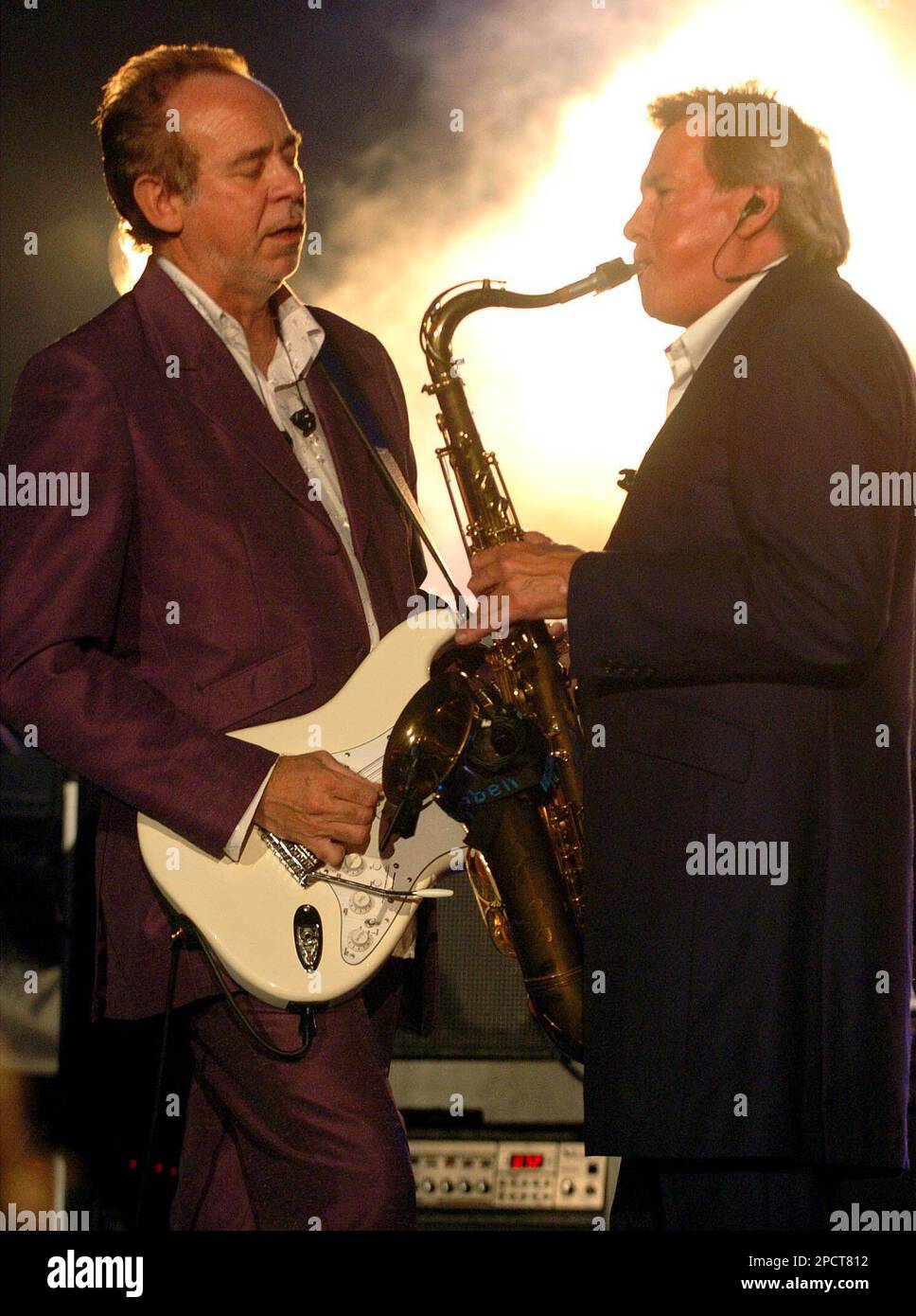 Phil Manzanera plays guitar next to Andy Mackay on saxophone during a ...