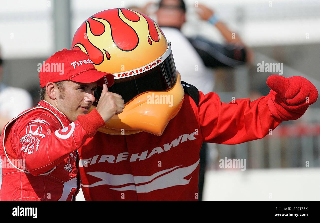 Dan Wheldon, left, of England, poses for photos with the Firestone ...