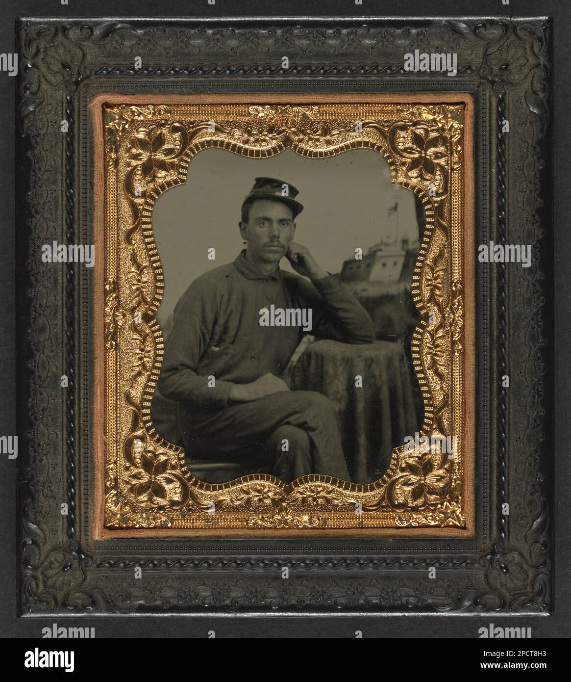 Unidentified soldier in Union uniform next to draped table in front of ...