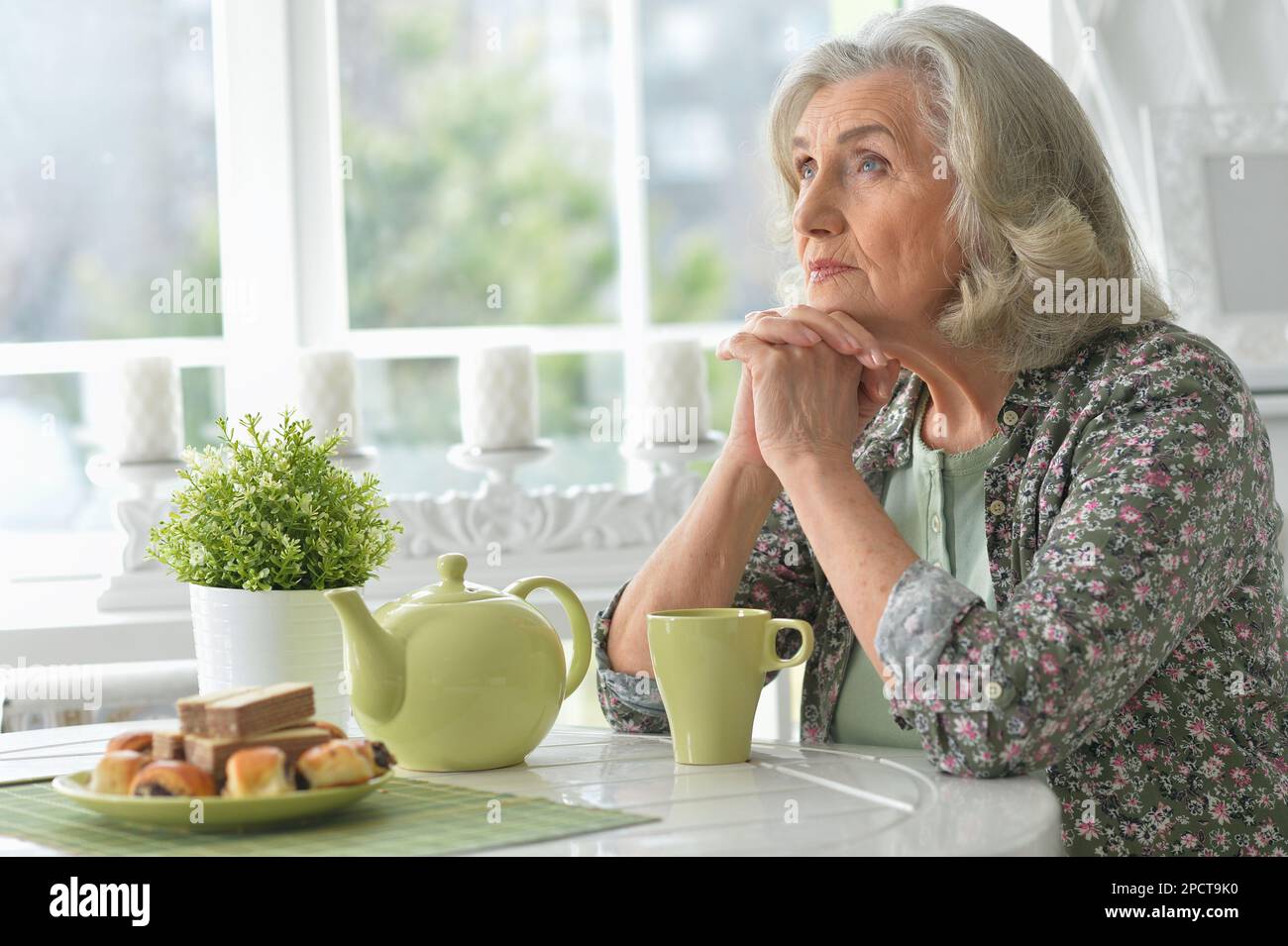 Beautiful sad senior woman drinking tea Stock Photo - Alamy
