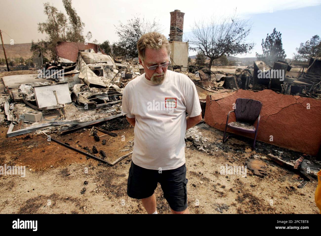 Rex Davis stands amid the remains of his home on Mountain View Lane in ...