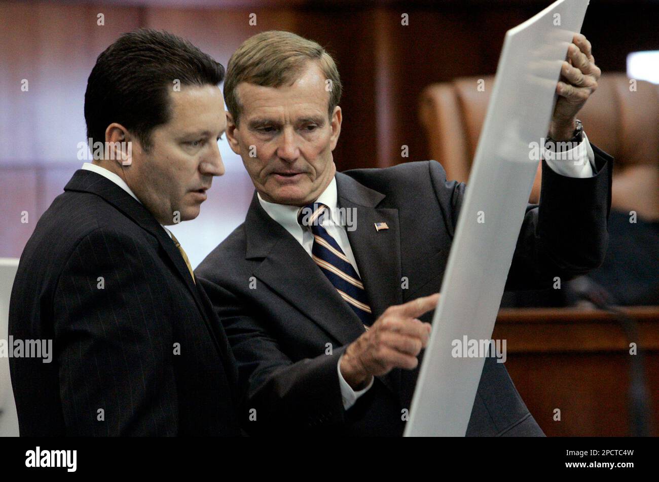 State Attorney John Tanner, right, shows photographs to be submitted as ...