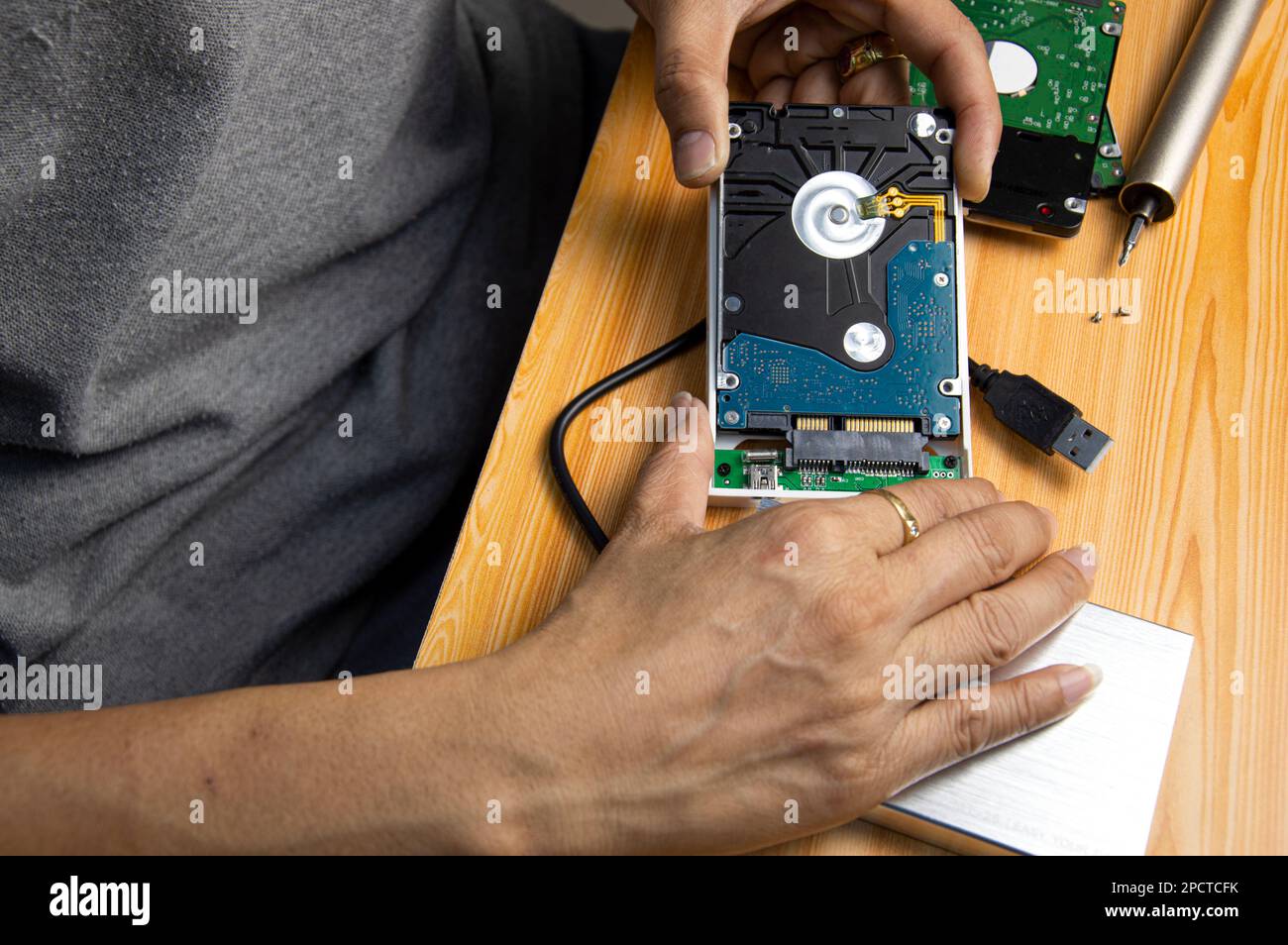 top view, man assembling an external hard drive Stock Photo - Alamy