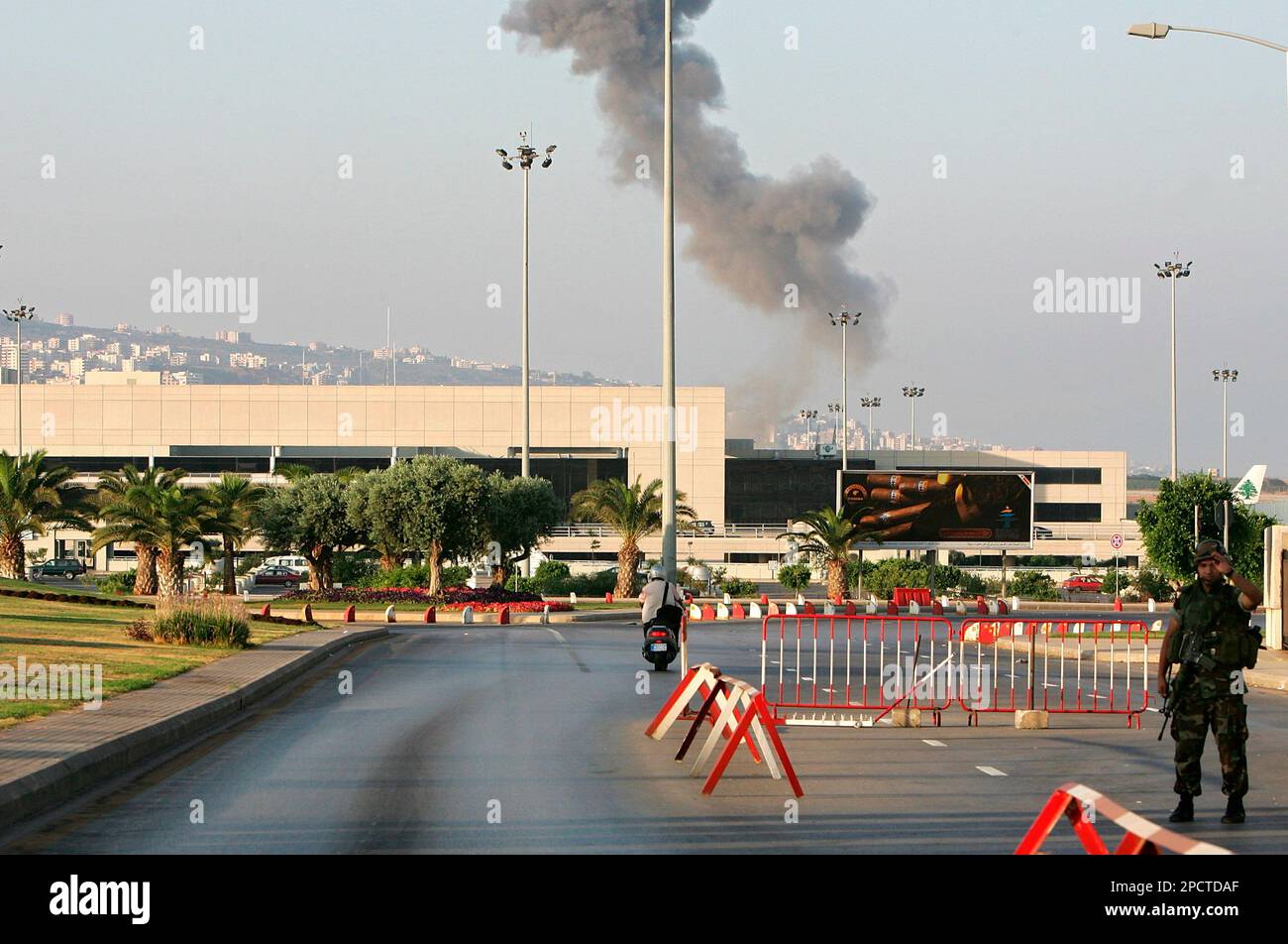 A Lebanese soldier stands guard at a permanent checkpoint as smoke ...