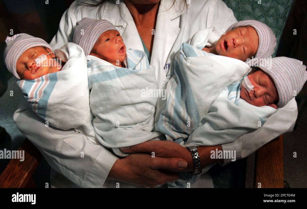 Kathryn Shaw, holds a set of quadruplets, two boys and two girls, born ...