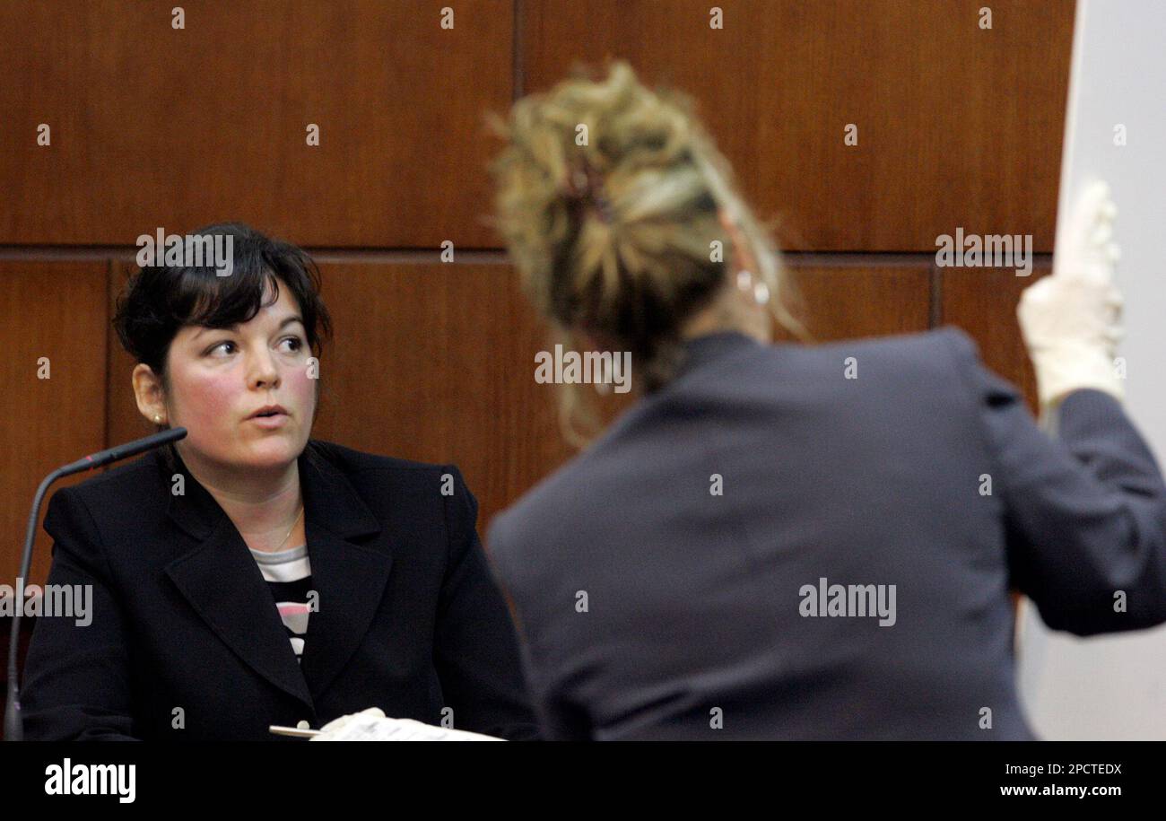 State attorney Leah Case, right, shows photographs of the body of Erin ...