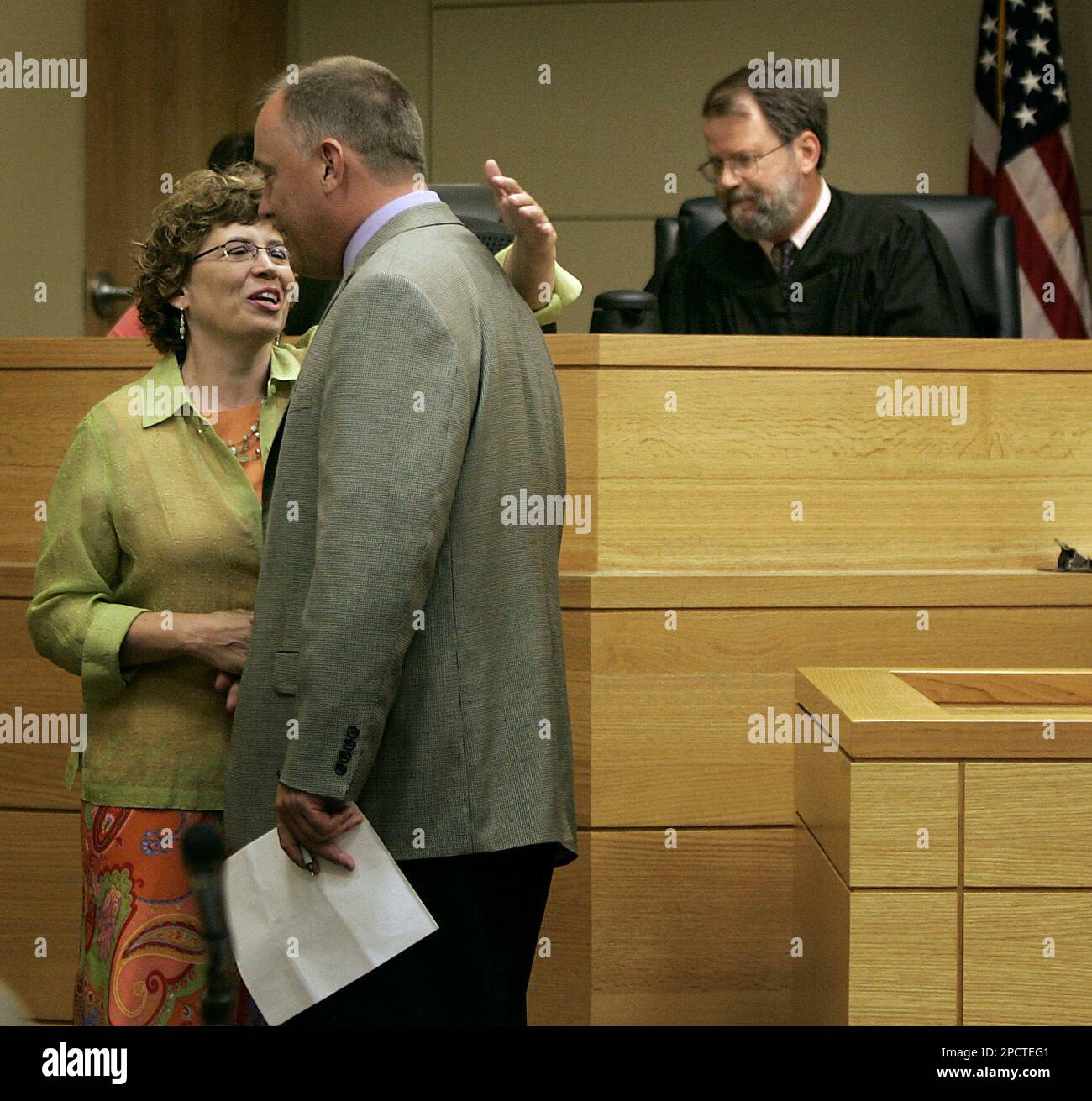 Toby Young, left, gives her lawyer Jim Yoakum a hug after she was ...