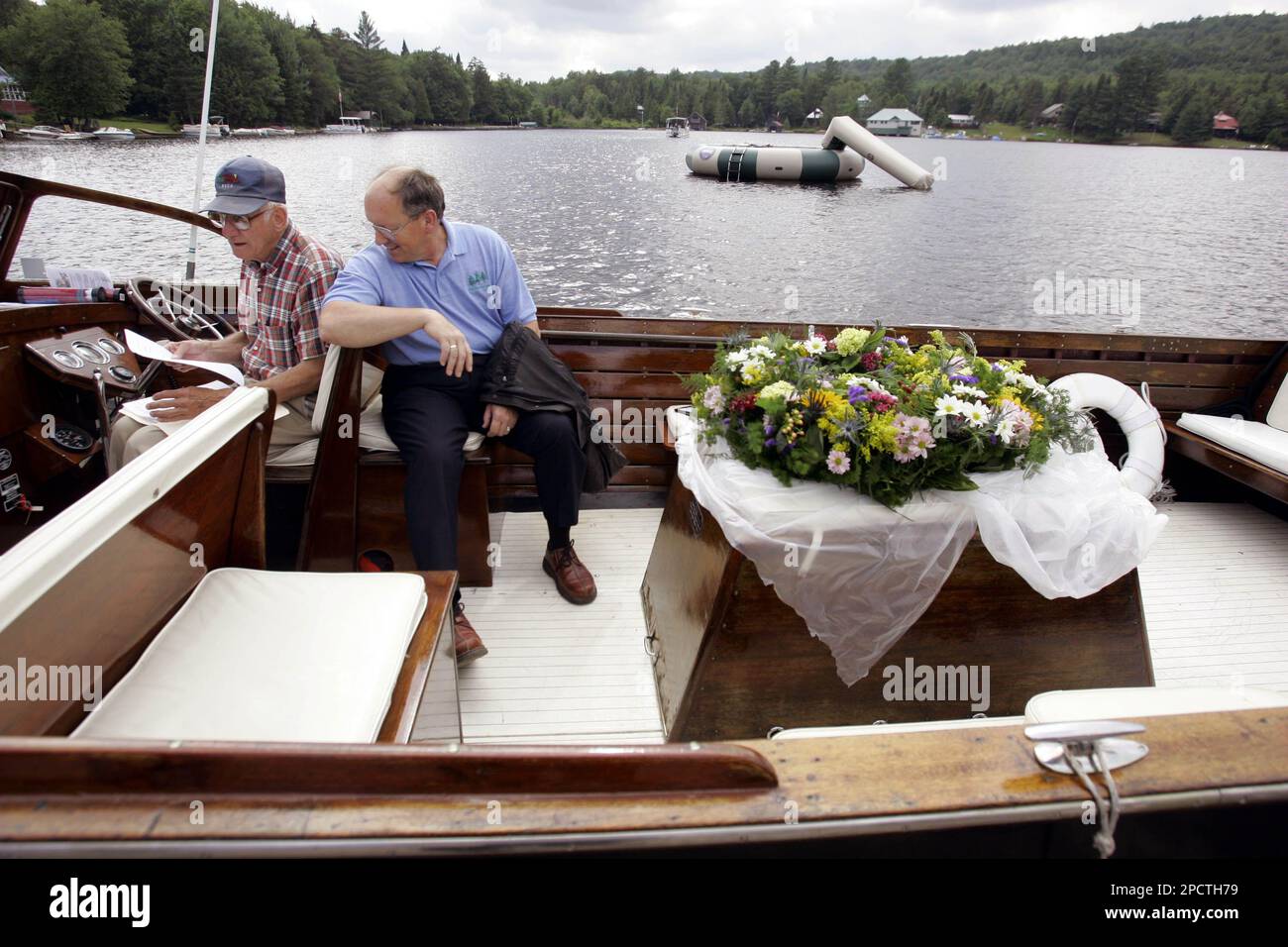 Charlie Adams, left, the pilot, and the Rev. Richard McCaughy, who gave ...