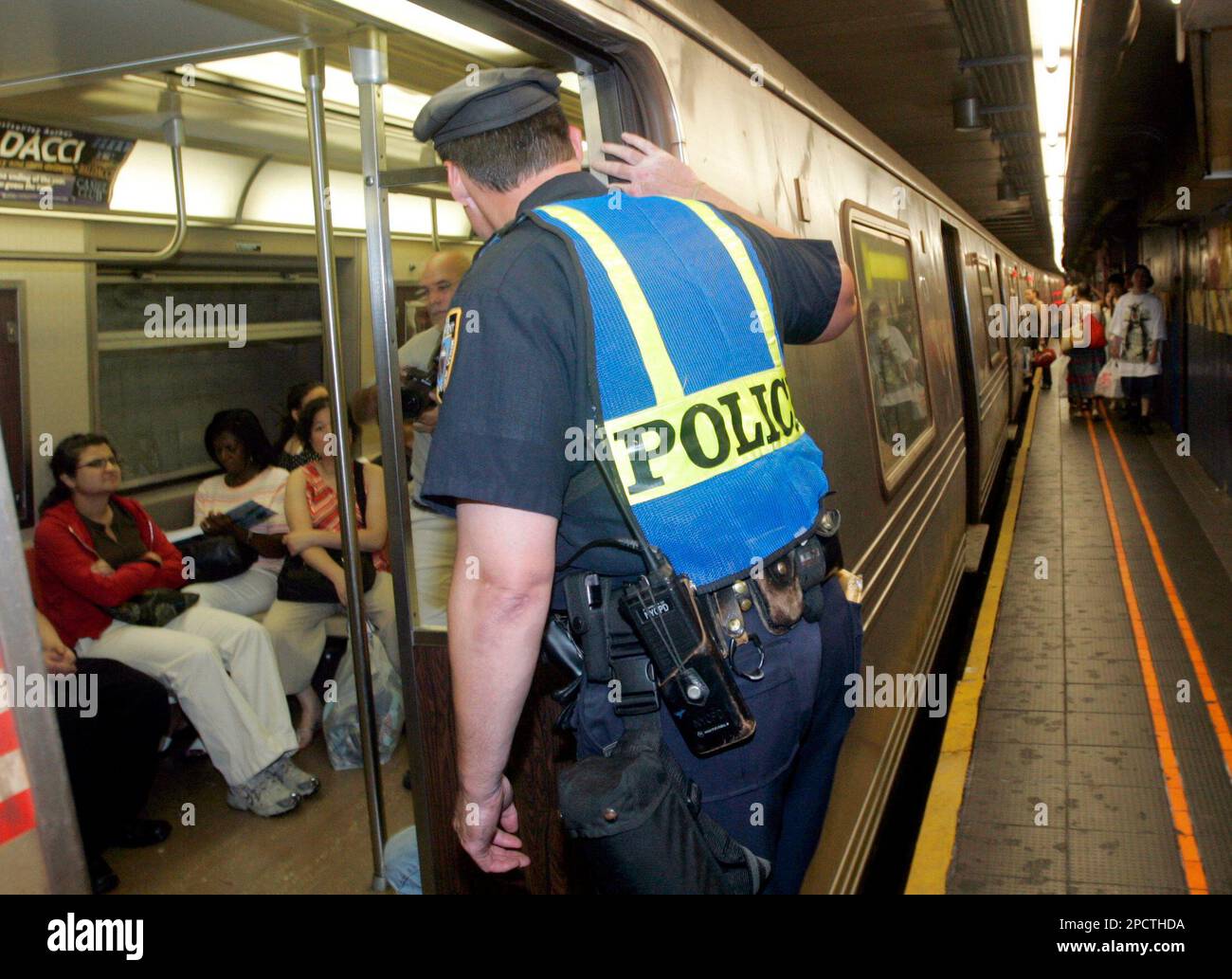 A New York Police Officer checks a subway car at the 34th street subway ...