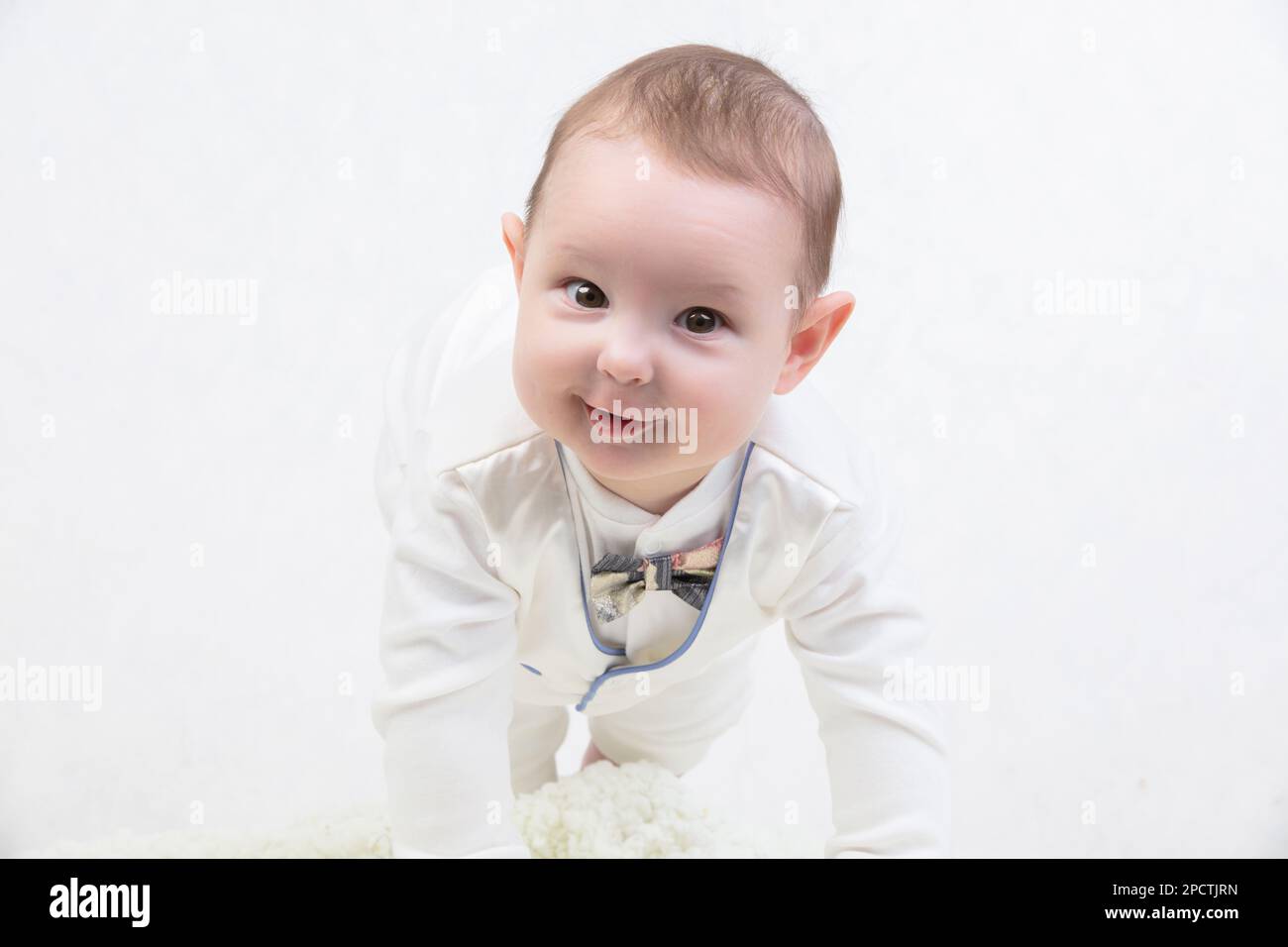 A smile on a child's face. Portrait of a six month old boy with a funny ...