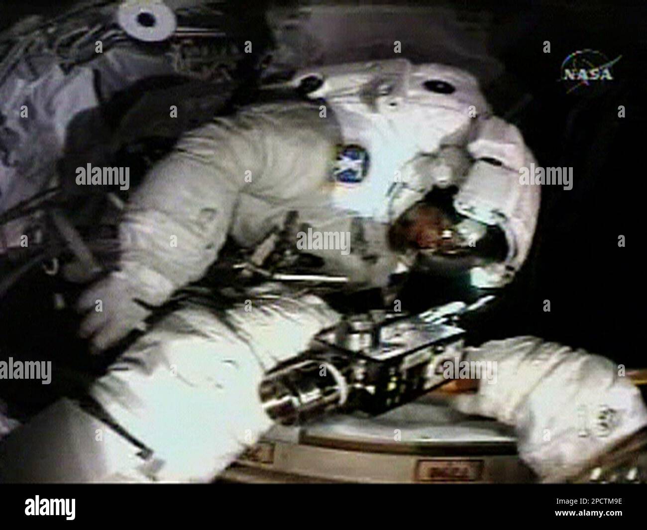 In this image made from NASA TV, astronaut Mike Fossum waits for ...