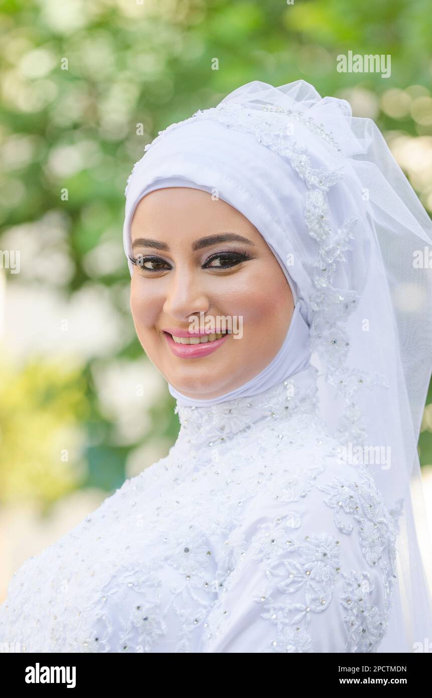 Beautiful Muslim bride in her wedding dress smiling outdoors Stock ...