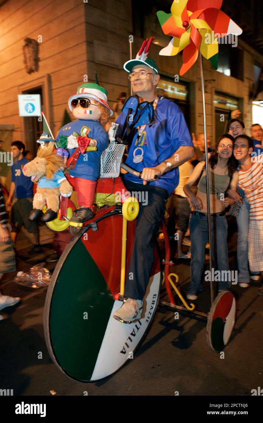 A man rides a self-made bicycle with the colors of the Italian flag in ...