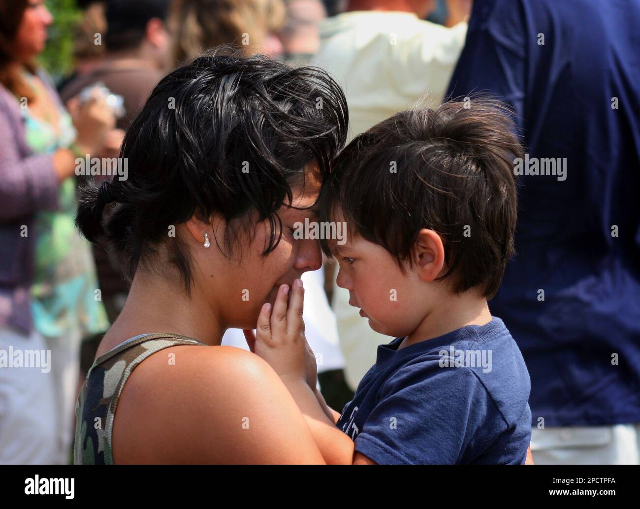 Melissa Hansen, left,, cries while hugging her son, Brady, after her ...