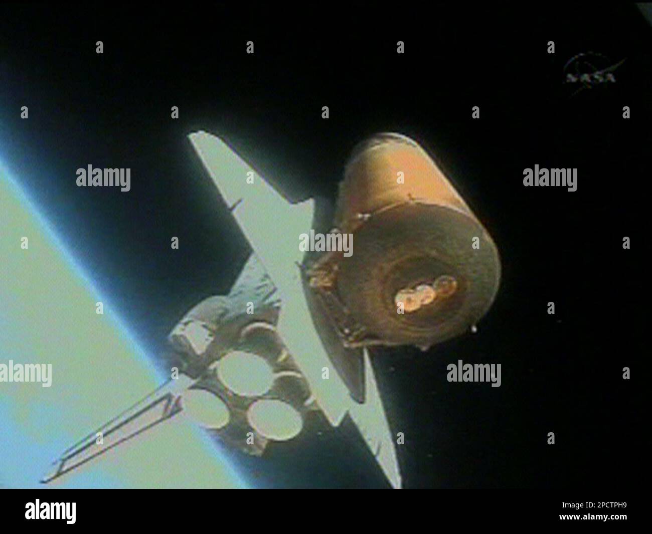 A camera attached to the solid rocket booster shows the Space Shuttle ...