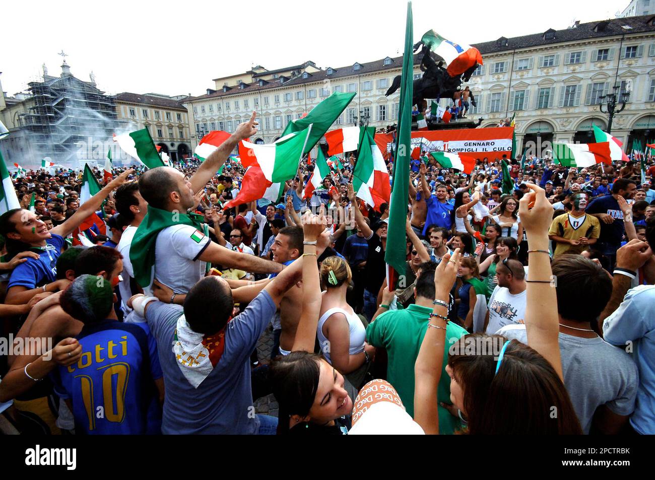Italian soccer fans wave their flags in Turin's Piazza San Carlo square ...