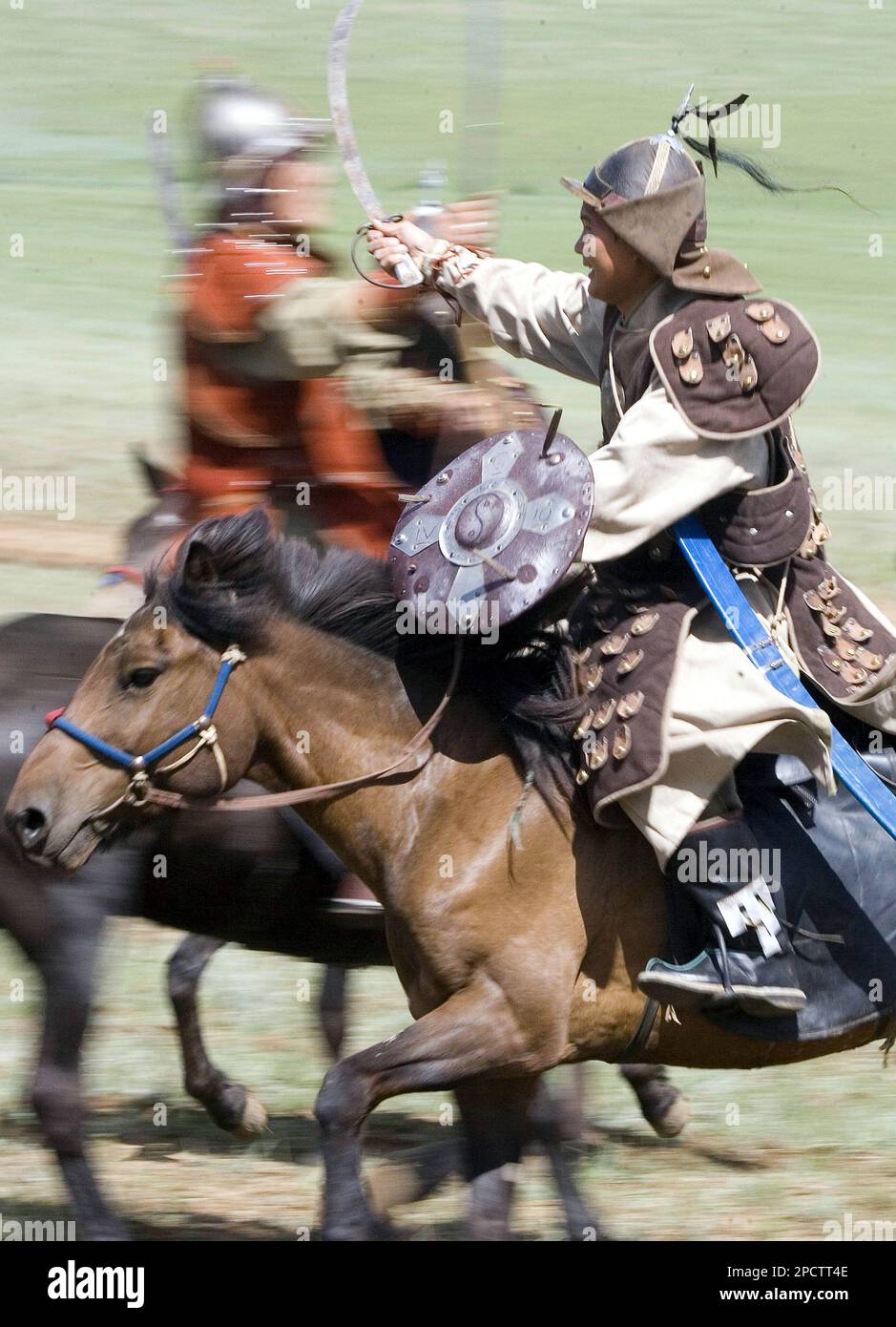 Mongolian soldiers in traditional warrior outfit cross scimitars as ...