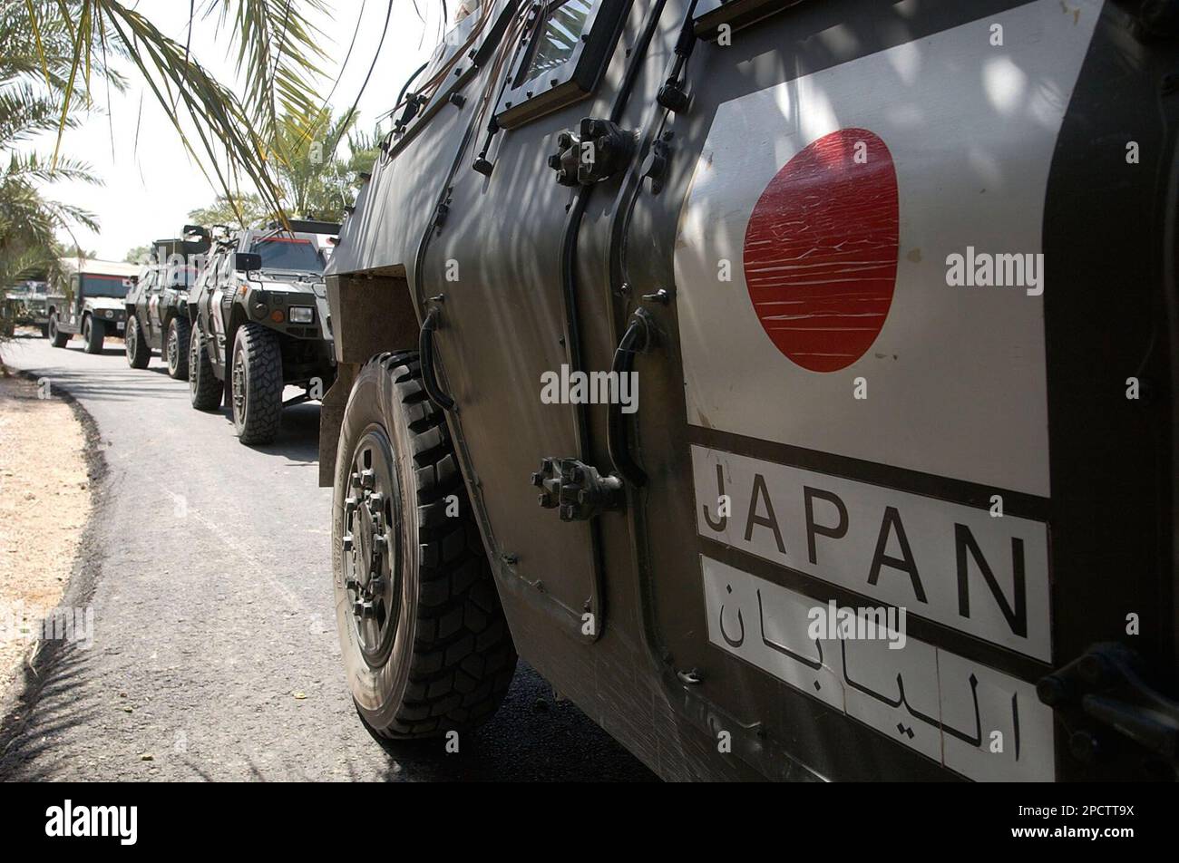 Japanese APC's line on a main road, Sunday, July 9, 2006, in Samawah ...