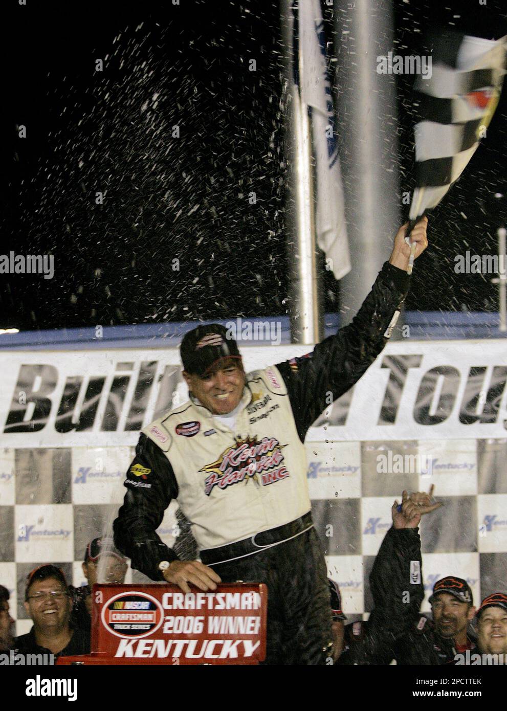 Ron Hornaday Jr. waves the checkered flag in victory lane after winning ...