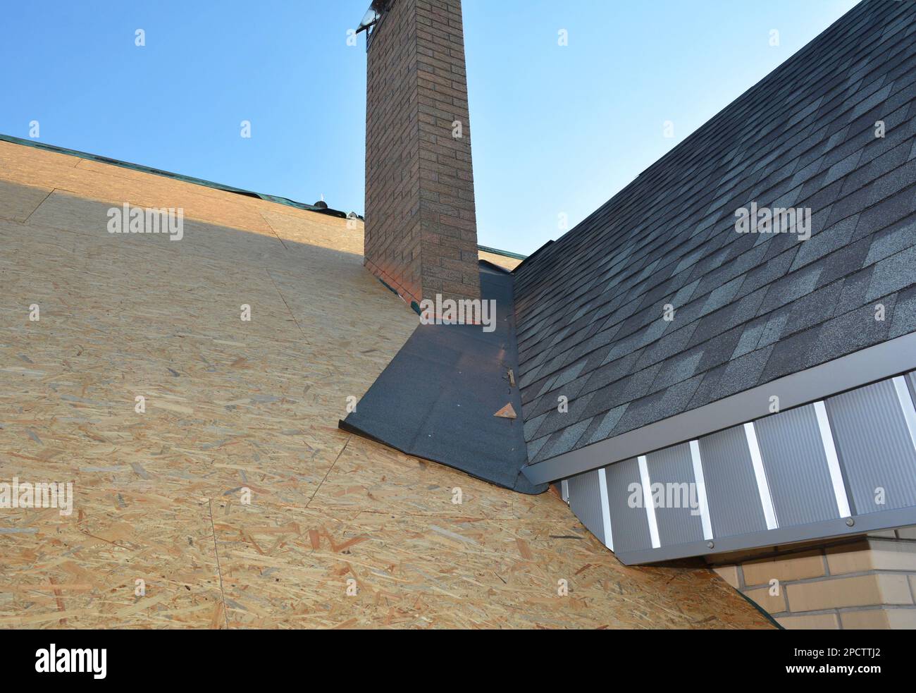 Roofing Construction with Asphalt Shingles corner waterproofing. Close ...