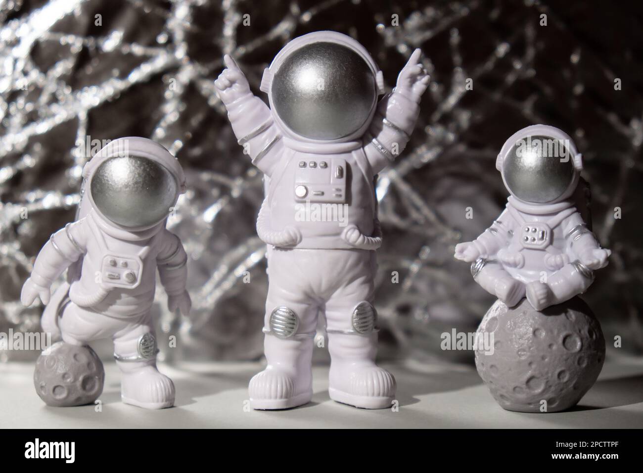 Three Plastic toys figure astronaut on silver background Copy space ...