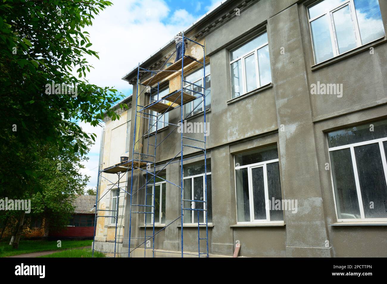 Building contractor applying stucco, plastering, and finishing the ...