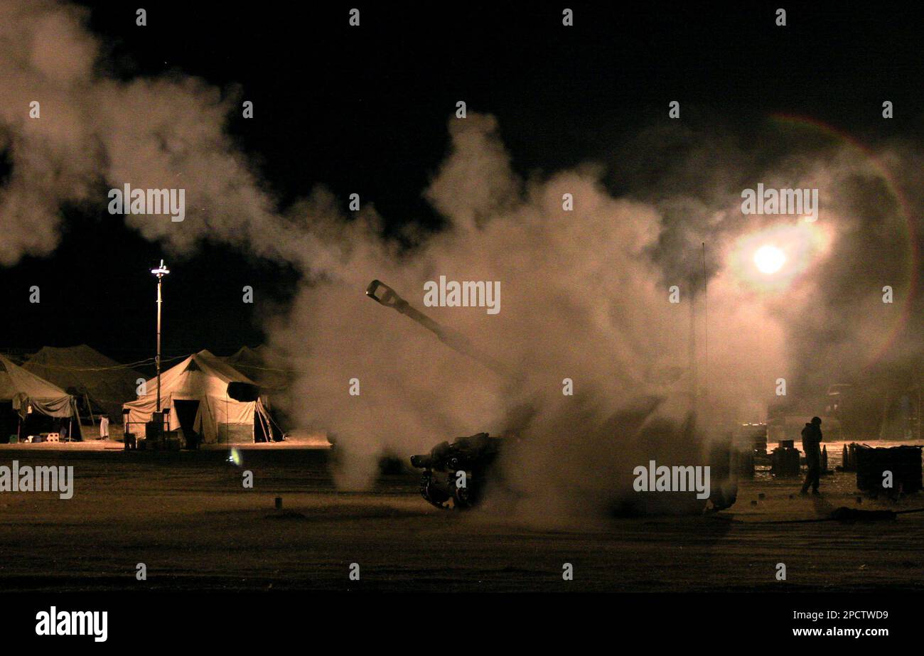 An Israeli army artillery cannon fires towards the Gaza Strip at a ...