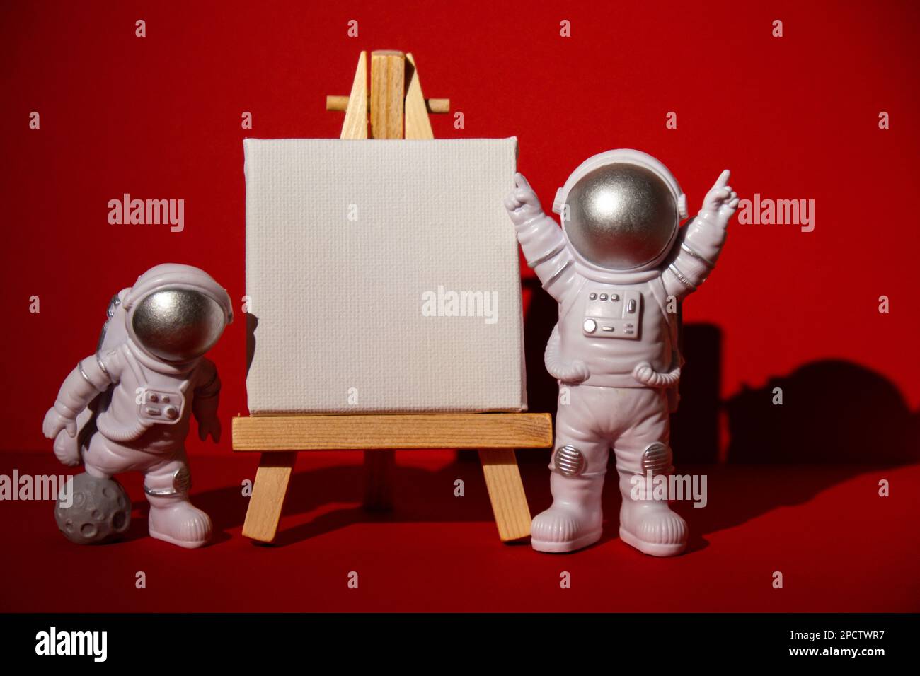 Plastic toy astronaut with paper note template mock up for your text on ...