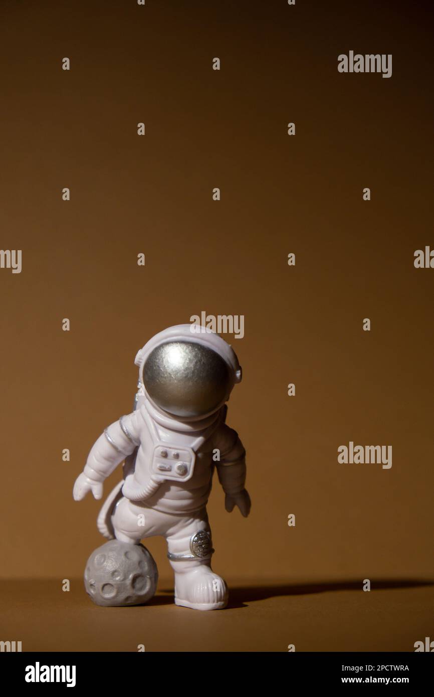 Plastic toy figure astronaut on beige neutral background Copy space ...