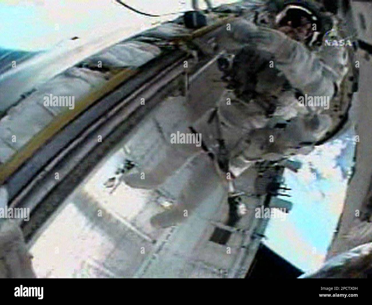 In this image made from NASA TV,astronaut Piers Sellers, works in ...