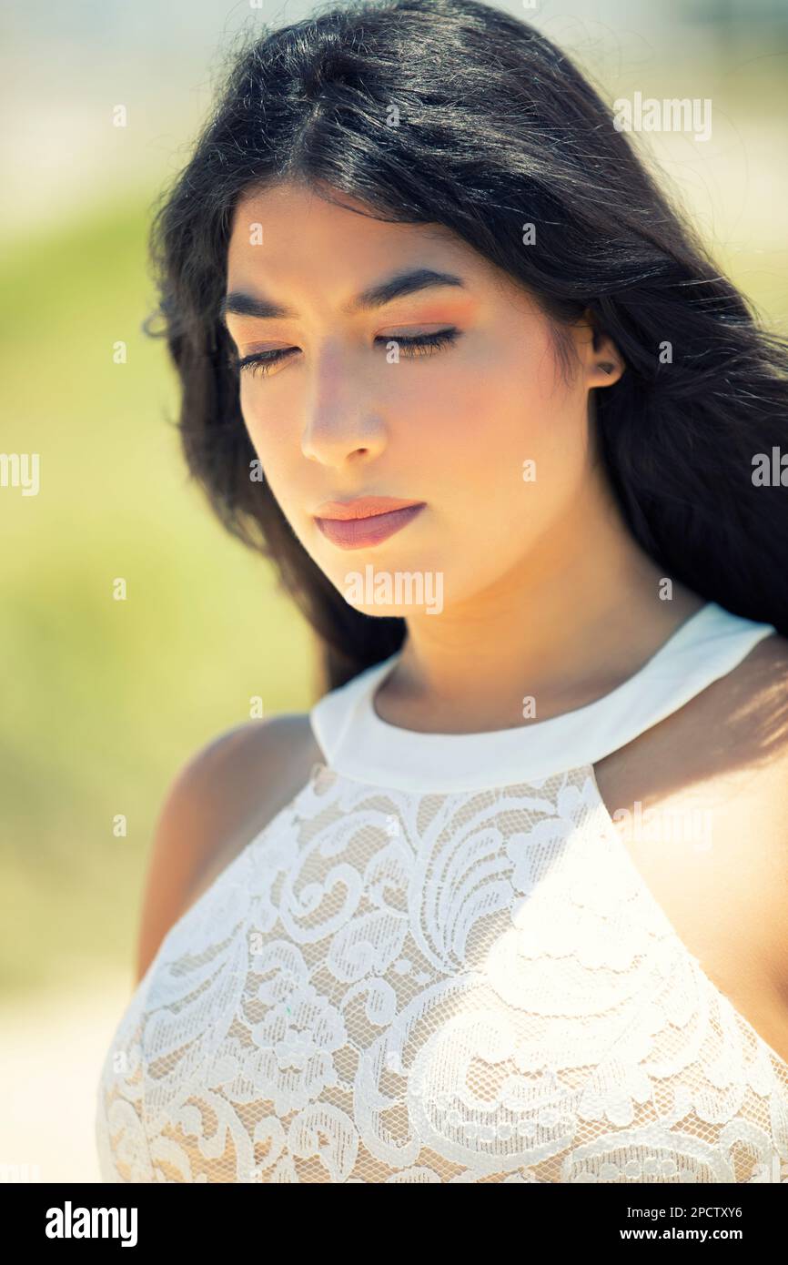 Beautiful young woman looking down Stock Photo - Alamy