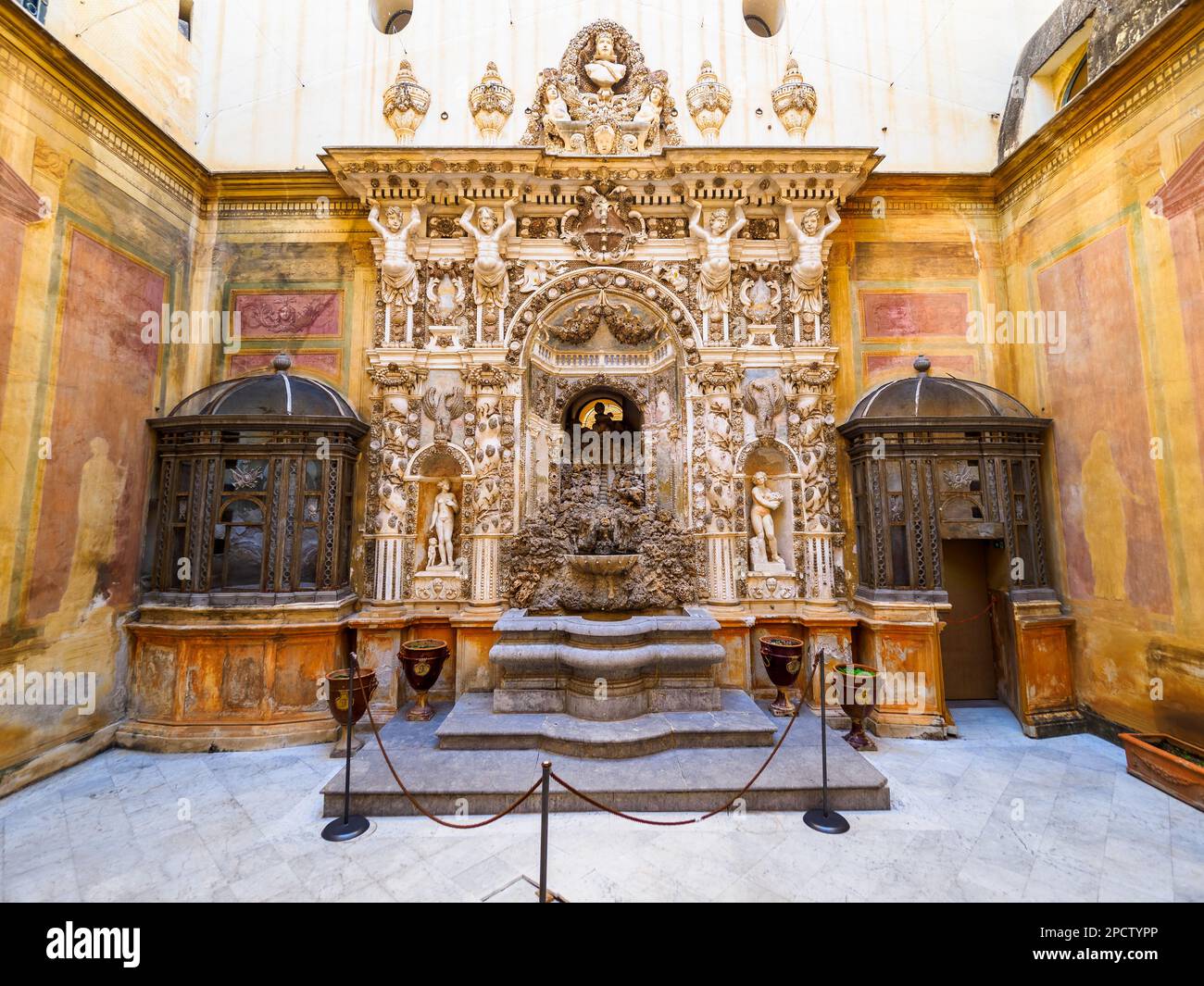 Baroque fountain with lateral aviaries built on a hanging courtyard in ...