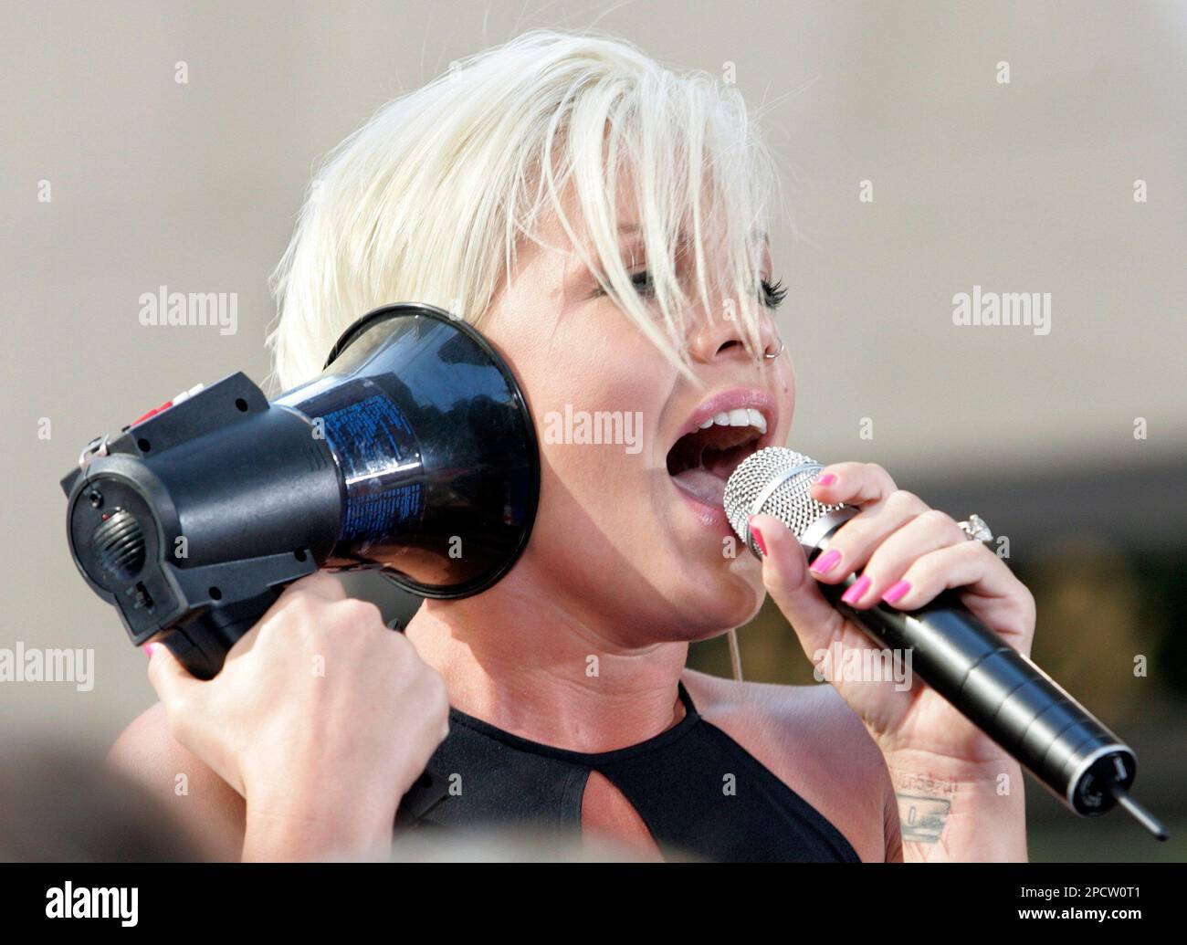 Singer Pink puts a megaphone to her ear as she performs on the NBC ...